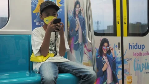 A boy is typing on a smartphone on the M... | Stock Video | Pond5