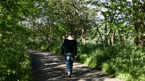 A boy walking in a path (back view) | Stock Video | Pond5