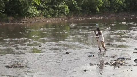A Boy Walks Across A River In Pakistan, ... | Stock Video | Pond5