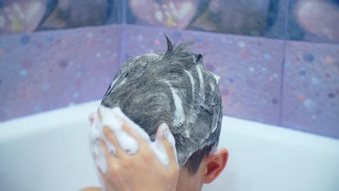 boy washes sitting in the bath | Stock Video | Pond5