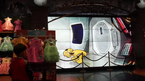 boy watching cartoon in Disney flagship ... | Stock Video | Pond5