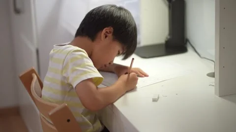 Boy writing a picture diary | Stock Video | Pond5