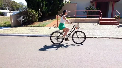 Brazilian beautiful woman riding a bike ... | Stock Video | Pond5