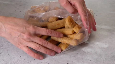 Breaded fish sticks are frozen. A plasti... | Stock Video | Pond5