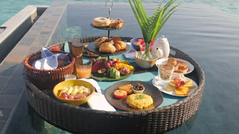 Breakfast floating in infinity pool abov... | Stock Video | Pond5
