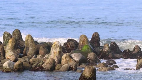 Breakwater on a beach breaks the waves, ... | Stock Video | Pond5
