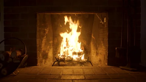 Brick fireplace with a roaring fire | Stock Video | Pond5