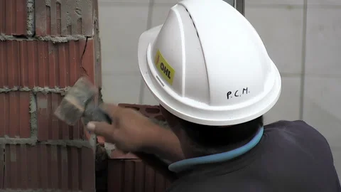 Bricklayer breaking a brick wall with a ... | Stock Video | Pond5