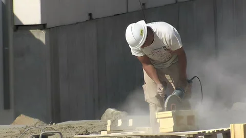 Bricklayer cutting a brick with a grinde... | Stock Video | Pond5