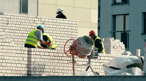 Bricklaying men team work together on wh... | Stock Video | Pond5