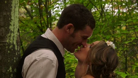 bride and groom kiss in beautiful forest... | Stock Video | Pond5
