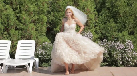Bride jump in swimming pool | Stock Video | Pond5