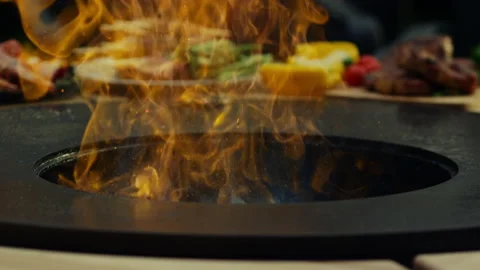 Bright fire flame burning in grill. Unkn... | Stock Video | Pond5