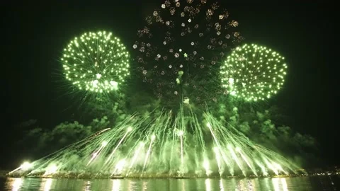 Bright green fireworks explode in air ag... | Stock Video | Pond5