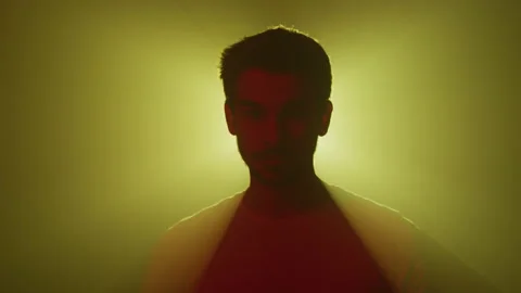 Bright light behind a male model | Stock Video | Pond5