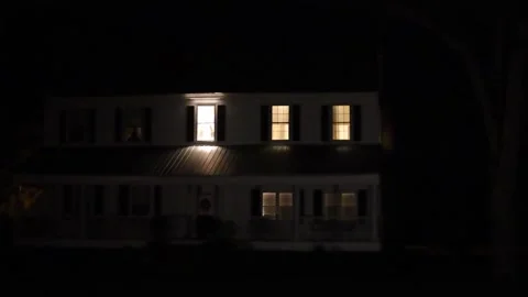 A bright light in a window in a house at... | Stock Video | Pond5