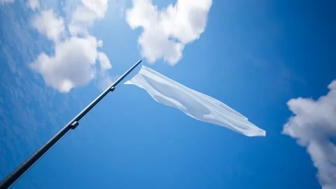 A bright white flag waving on the wind w... | Stock Video | Pond5