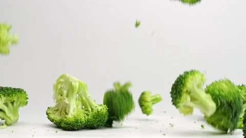 Broccoli pieces falling and bouncing in ... | Stock Video | Pond5