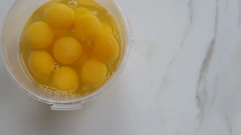 Broken eggs rotate in the frame. Real ti... | Stock Video | Pond5