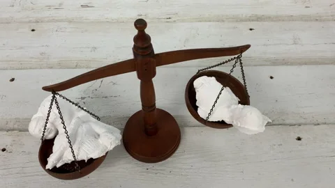 Broken family statuette on the scales of... | Stock Video | Pond5