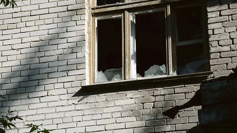 Broken glass in the window frame. Facade... | Stock Video | Pond5