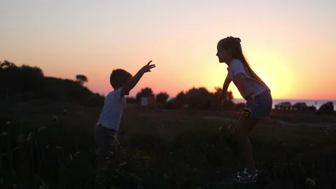 Brother and sister run to each other and... | Stock Video | Pond5