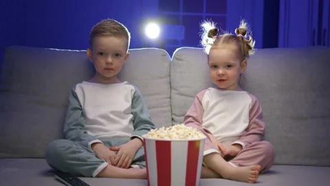 Brother and sister watch cartoon at movi... | Stock Video | Pond5