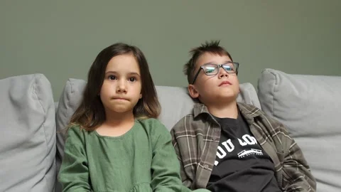 Brother and sister watching tv feeling b... | Stock Video | Pond5