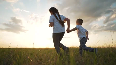Brother sister running on grass. sibling... | Stock Video | Pond5