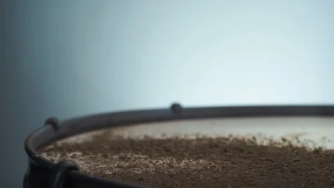 Brown holi powder bounces off drum in sh... | Stock Video | Pond5