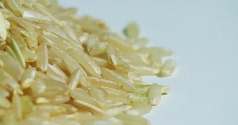 Brown Rice Pile Close Up Edge on White S... | Stock Video | Pond5