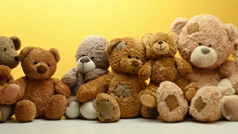 Brown teddy bears sit in a row, camera m... | Stock Video | Pond5