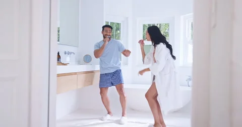 Brushing teeth, happy dancing and couple... | Stock Video | Pond5