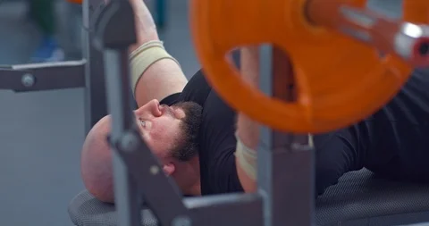 Brutal man doing a bench press lying. Wo... | Stock Video | Pond5