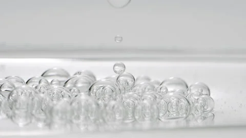 Bubbles fall to fluid surface with anoth... | Stock Video | Pond5