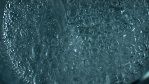 Bubbling water pouring glass top view. C... | Stock Video | Pond5