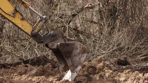Bucket of backhoe digging soil at constr... | Stock Video | Pond5