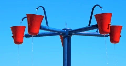 Buckets spilling splashing water at kids... | Stock Video | Pond5
