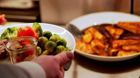 buffet guests put food on a plate | Stock Video | Pond5