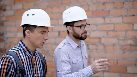 Builder walking and communicating on bac... | Stock Video | Pond5