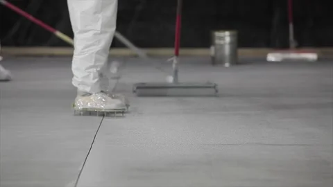 Builders are making a polymer floor in t... | Stock Video | Pond5