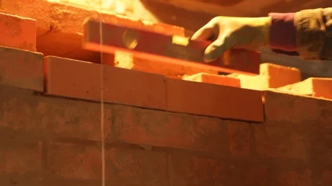 The Builder's Hand Puts The level on bri... | Stock Video | Pond5
