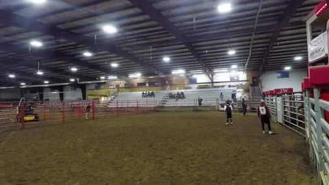 Bull riders practice riding bulls inside... | Stock Video | Pond5