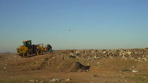 A bulldozer enters a dumping ground load... | Stock Video | Pond5