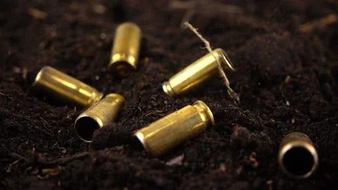 Bullet casings from a 5mm pistol fall to... | Stock Video | Pond5