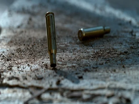 Bullet casings falling to the floor in s... | Stock Video | Pond5