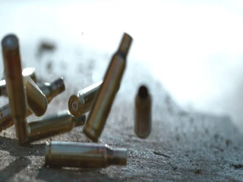 Bullet casings falling to the floor in s... | Stock Video | Pond5