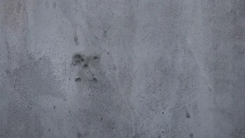 Bullet hits in a concrete wall. | Stock Video | Pond5