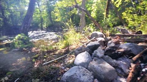 Burning camping fire beside the river in... | Stock Video | Pond5