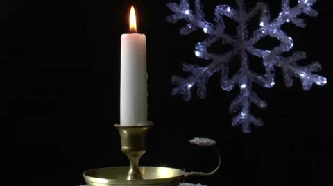 A burning candle is turning against a bl... | Stock Video | Pond5